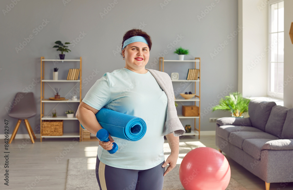 Young funny fat woman going to do sport exercises, holding yoga mat and ...