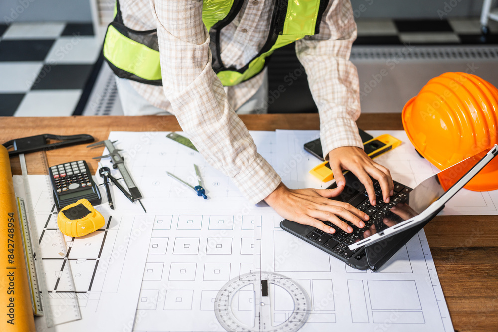 Female architect engineer is drafting blueprints using CAD software ...