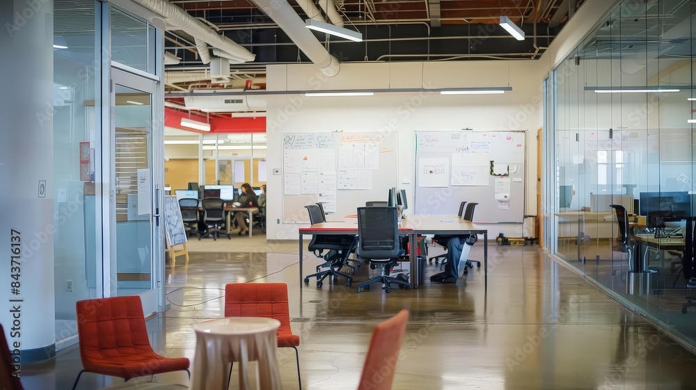 Modern open plan office space with glass partitions, desks, chairs ...