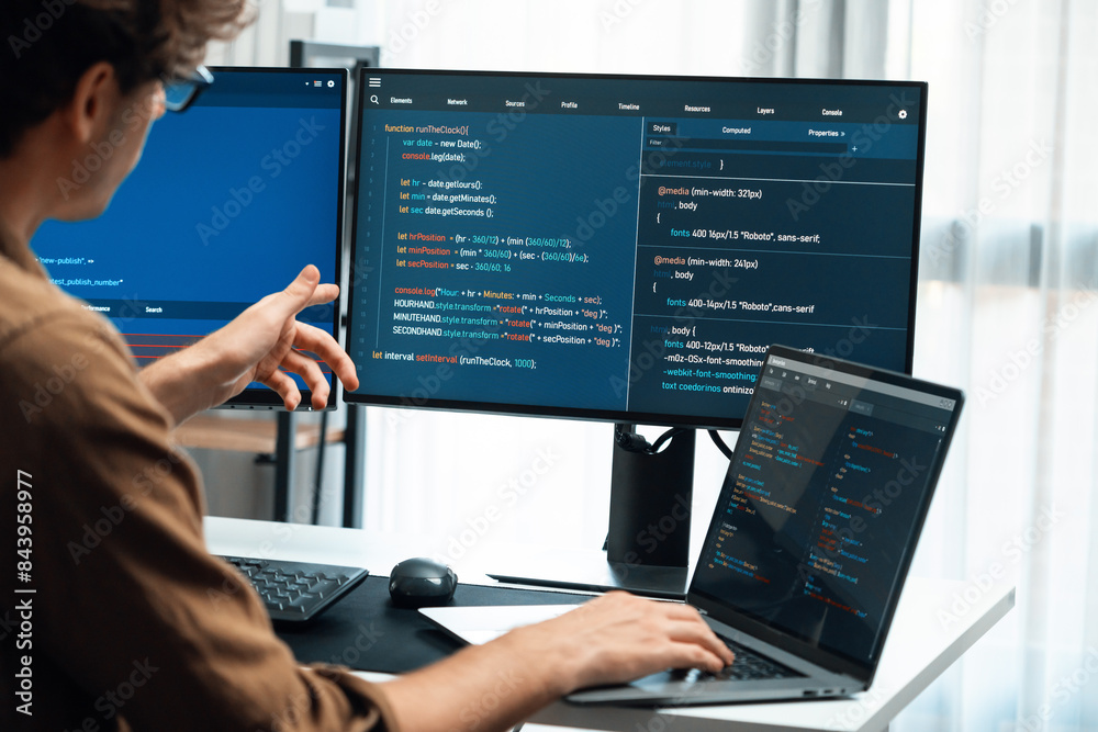 IT developer working online software development on pc monitors at ...