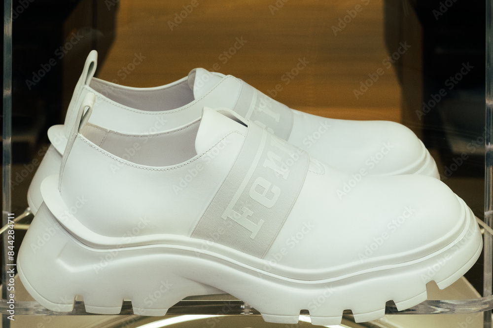 White Ferrari slip-on sneakers with big logo on upper, lugged sole ...