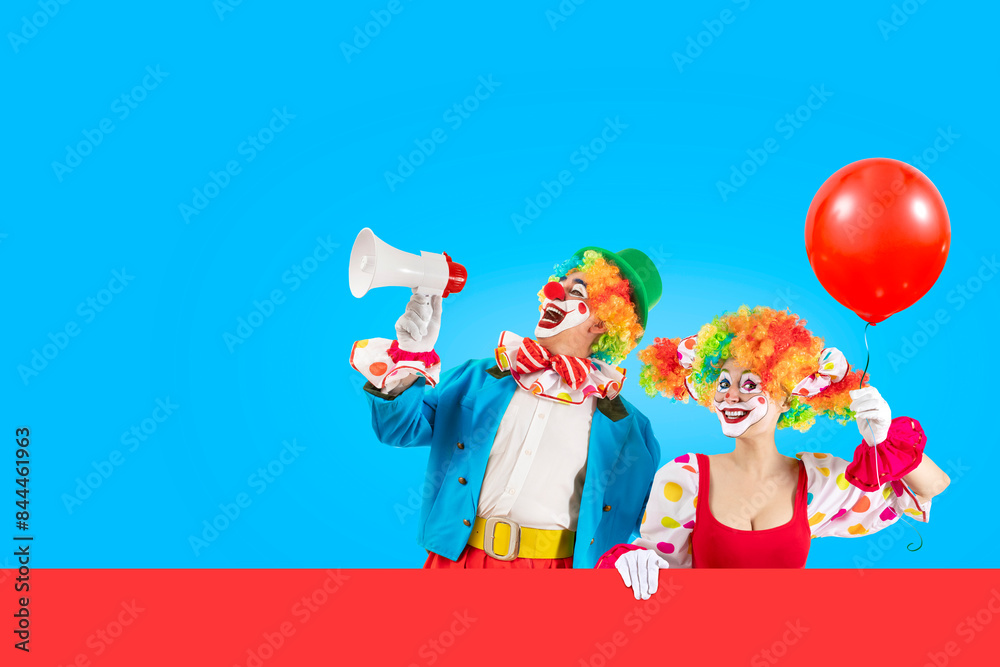 Funny clowns with baloon shouting with loudspeaker. Entertainer Joker ...