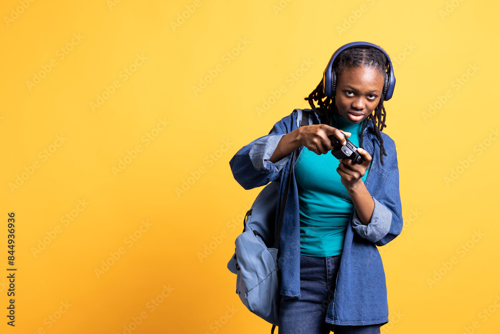 Portrait of young girl playing videogames with controller, hearing ...