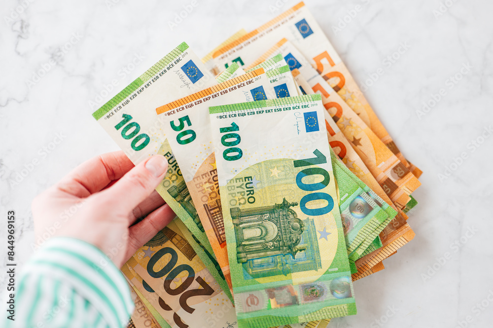 Euro bills on a marble background.Womens salaries and earnings in ...