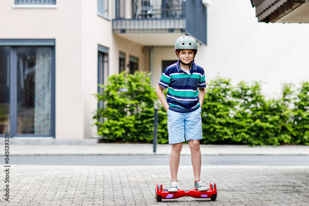 Active kid boy on hover board. Child driving modern balance hoverboard ...