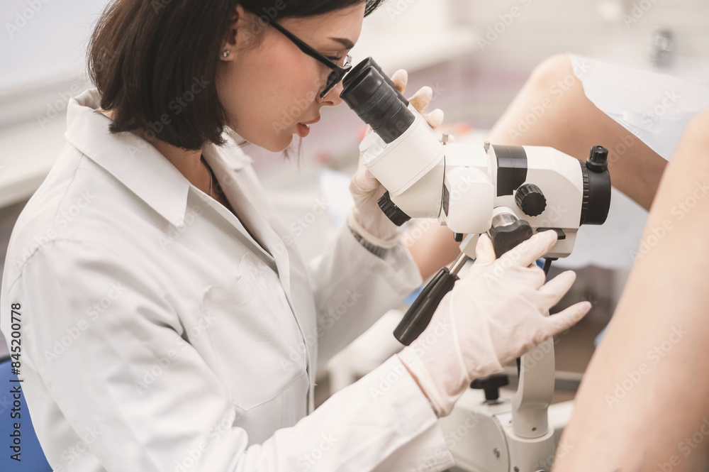 woman doctor look microscope at gynecologist's appointment. Female ...