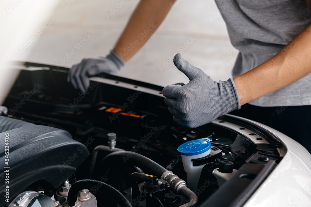 Hand of client showing thumb up for approval of car repair work ...