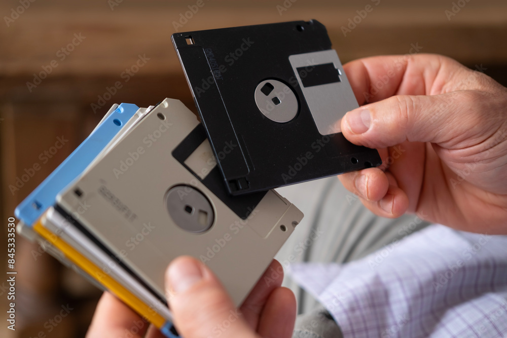 mature male hand holding vintage electronic data storage devices ...
