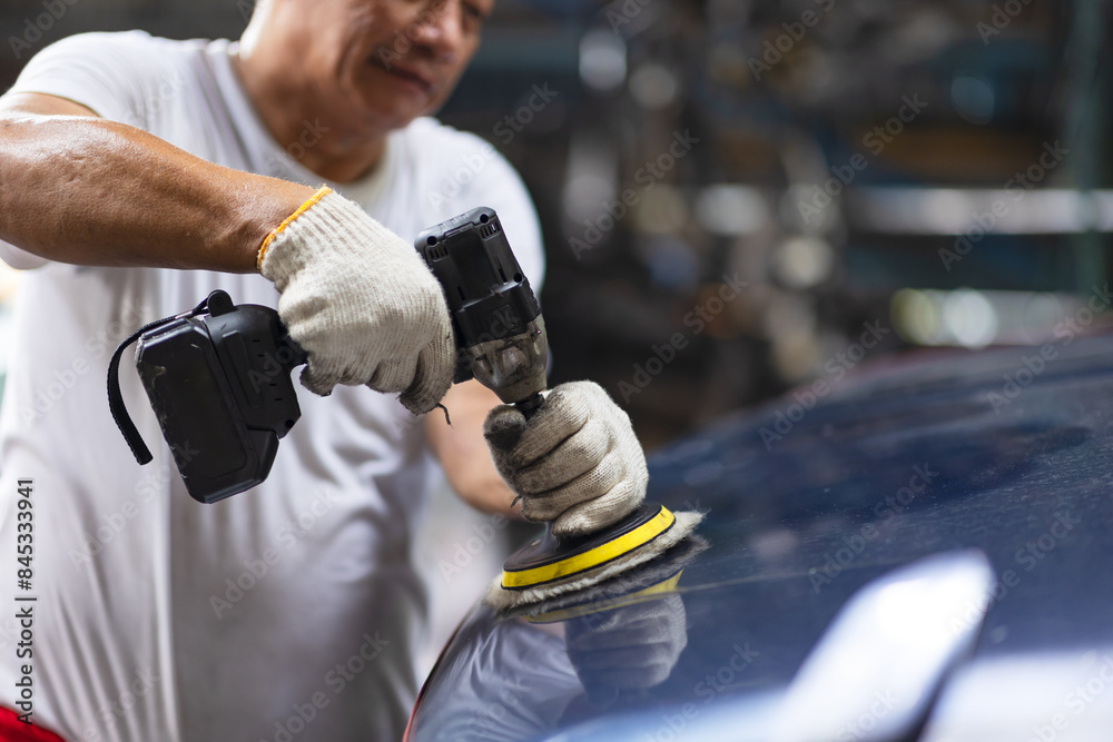 Car polishing, Worker in Auto workshop using color polisher machine ...