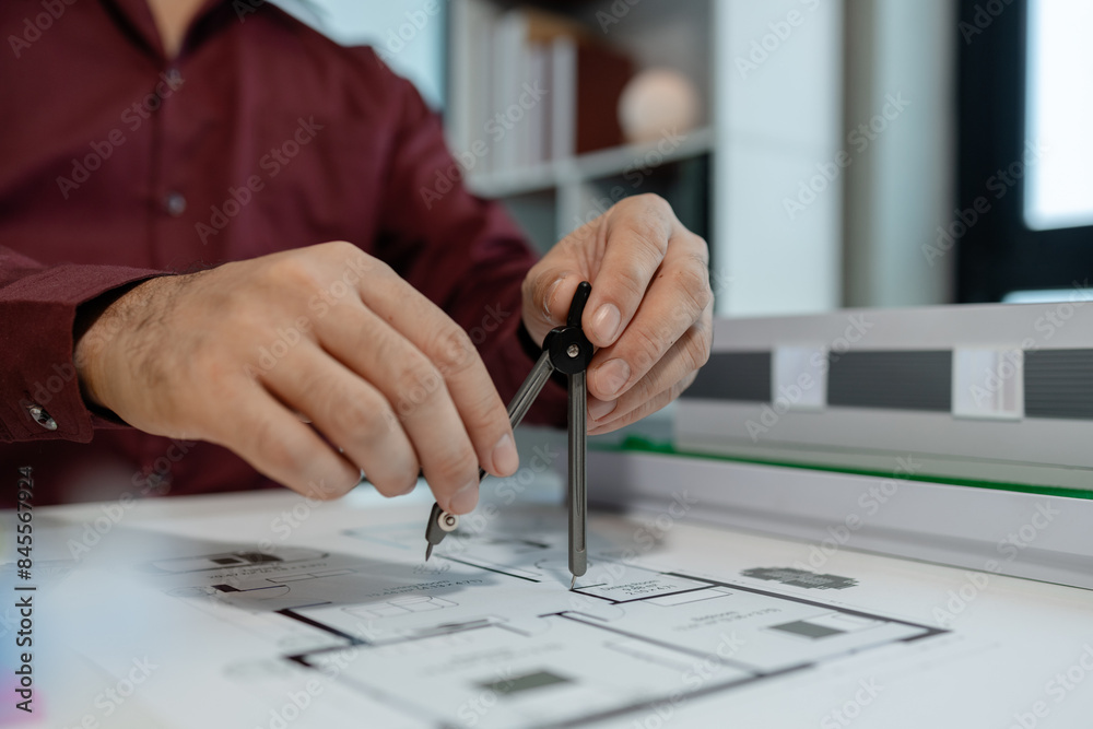 an architect is working on blueprint to finish in on time, architect is ...