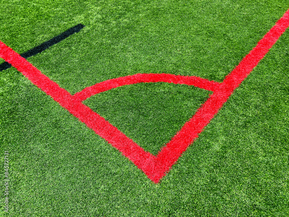 Red Corner Lines on Green Turf Sports Field. Red boundary markings on a ...