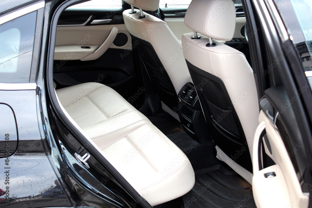 Light Leather back passenger seats in modern luxury car. Beige leather ...