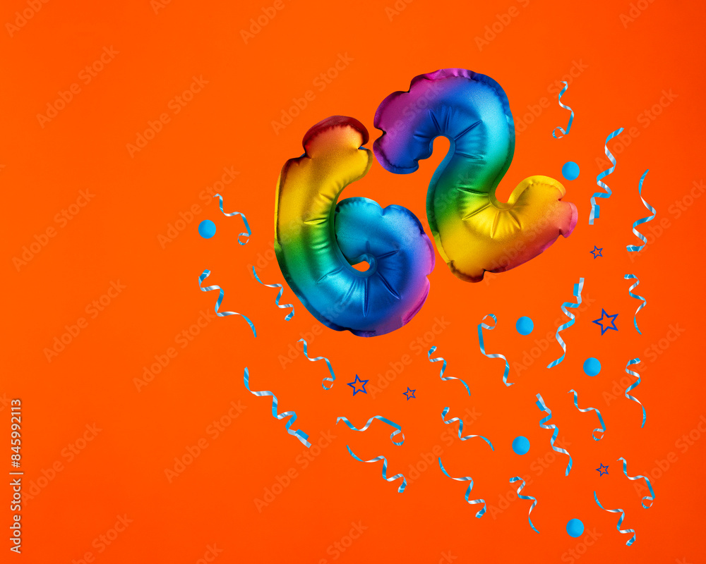 Confetti explosion with number 62 balloon - Celebration on orange ...