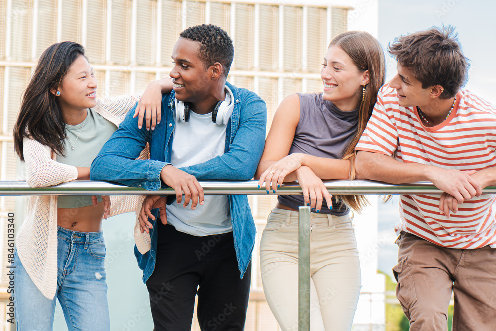 Diverse group of teenage students talking on a university campus ...