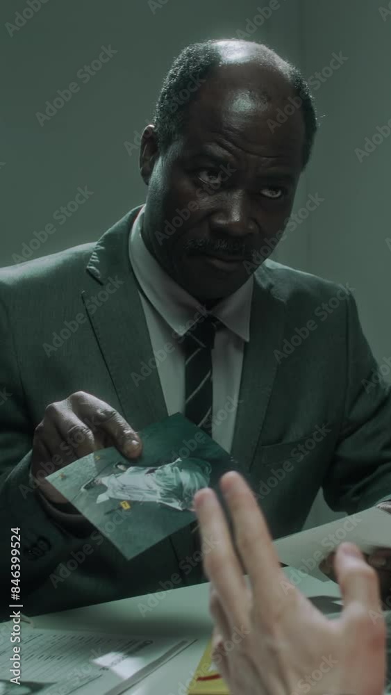 Medium vertical shot of black male federal agent or police officer ...