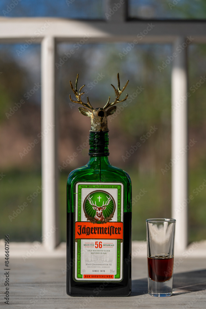 Jagermeister traditional herb liqueur in glass green bottle with ...