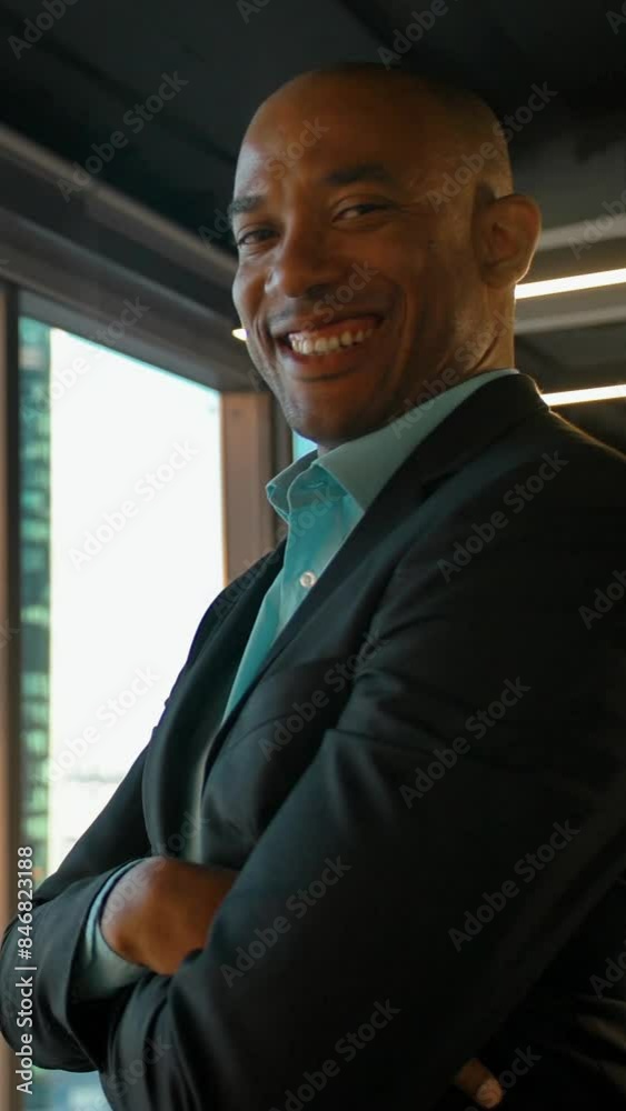 African american boss standing near huge modern office window and ...
