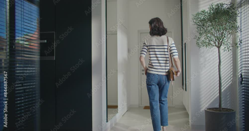 Charming Caucasian girl coming up close to mirror. Checking look and ...