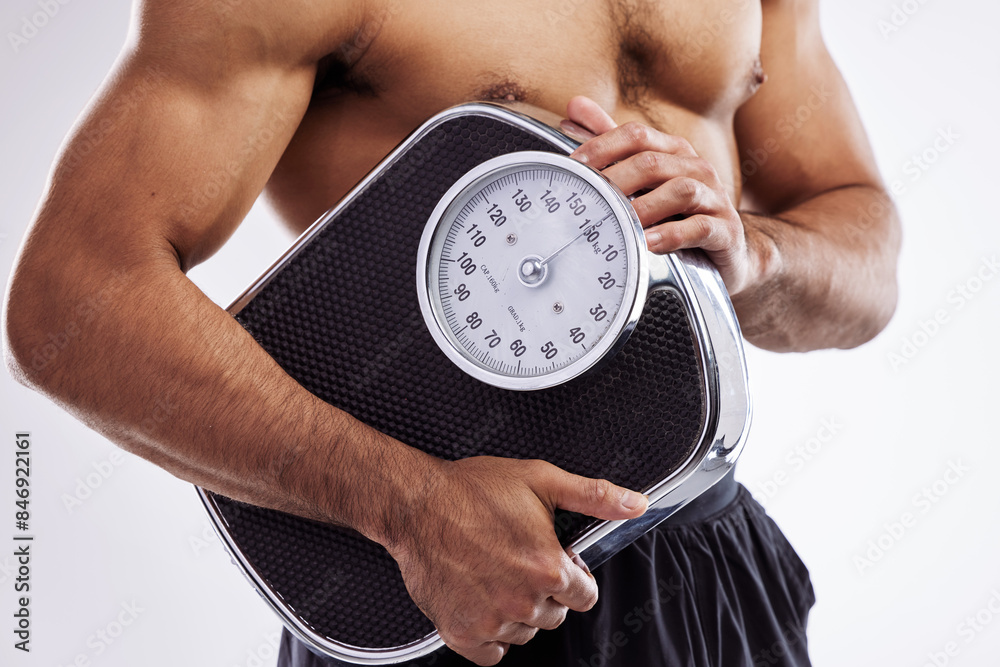 Man, muscle and fitness holding scale in studio white background for ...