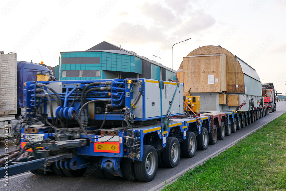Very long specialized multi axle truck trailer carries very heavy ...