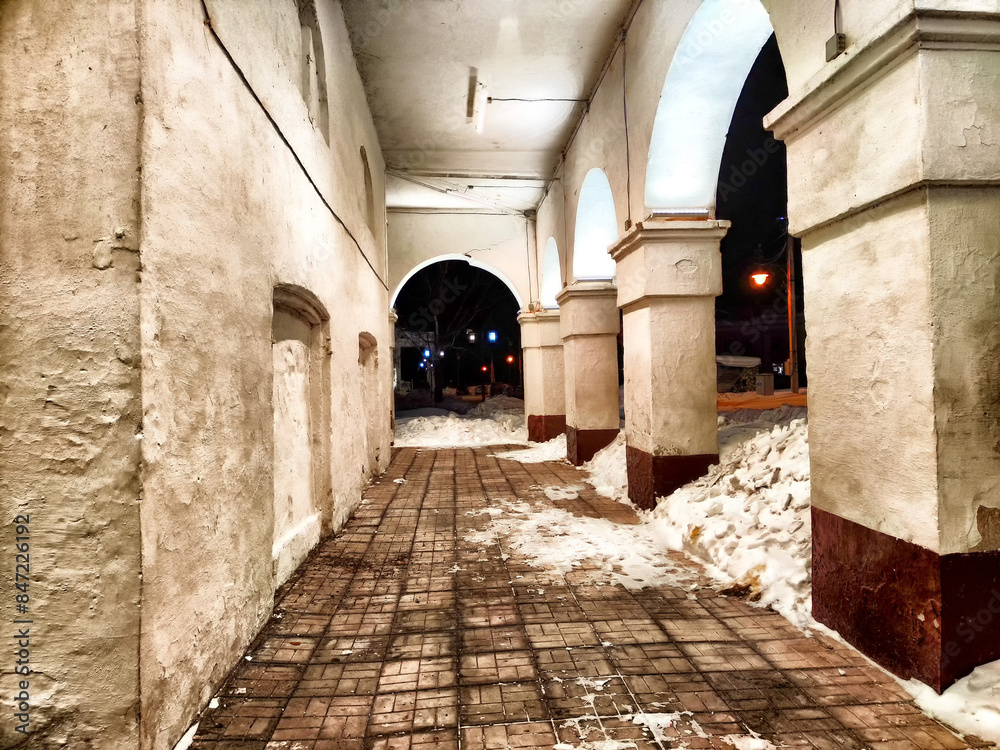 Old Ancient Colonnade Pathway at Night. Dimly lit corridor with arches ...