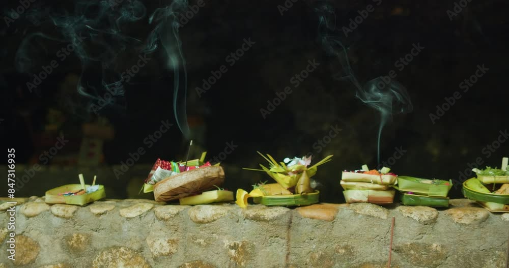 Wicker baskets with offerings to Hindu God and burning aroma sticks ...