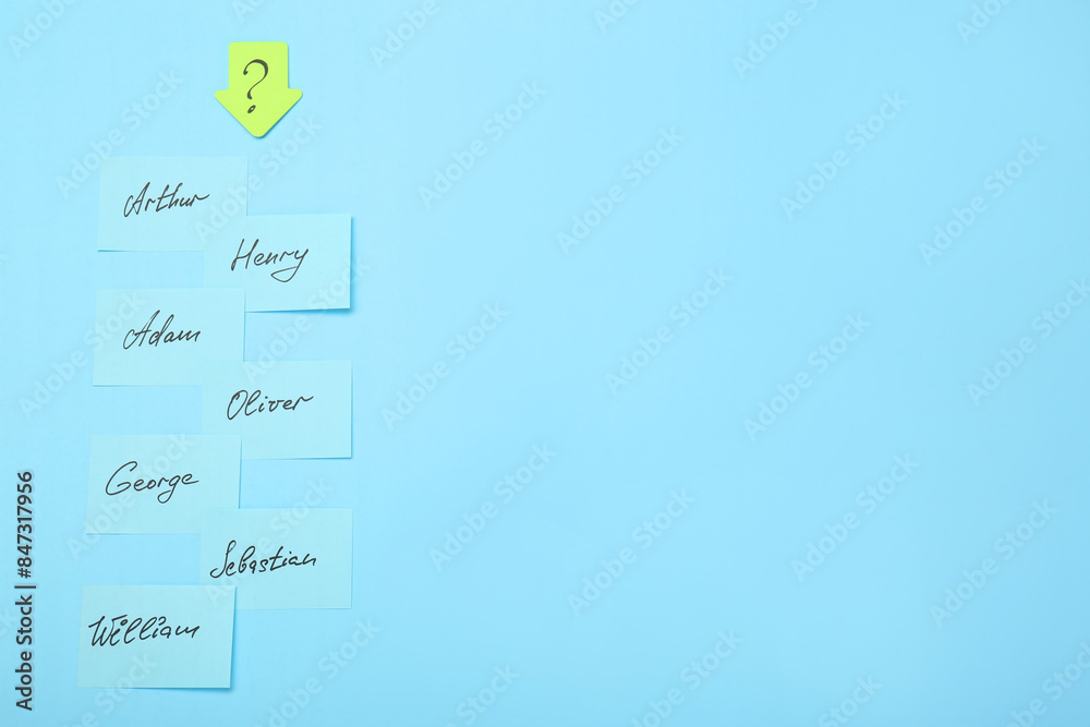 Choosing baby name. Paper stickers with different names and question ...
