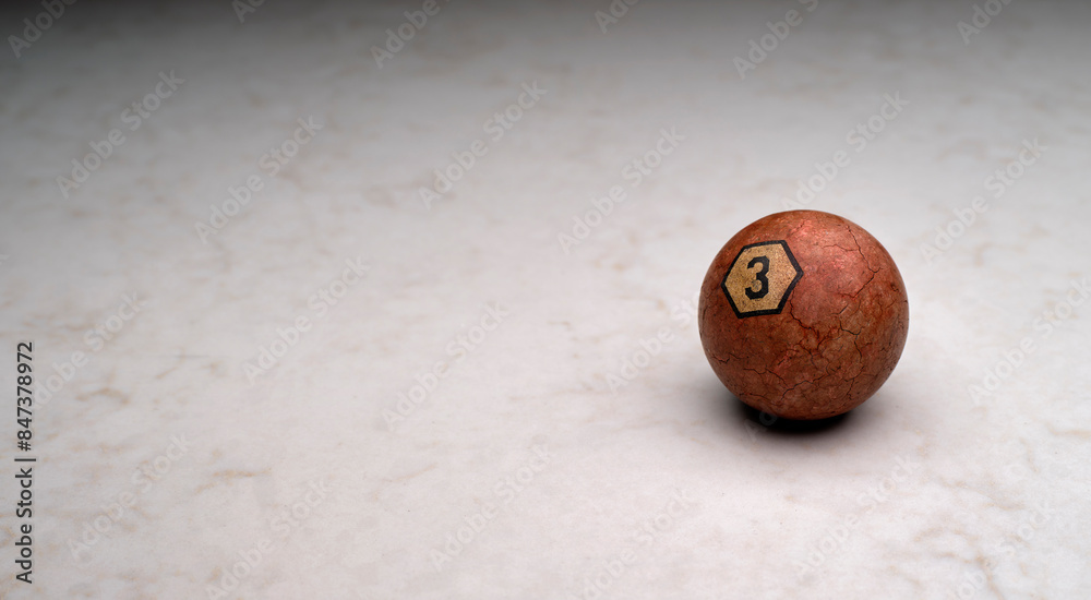 Vintage billiard ball. Red number 3 pool ball. Cracked clay surface and ...