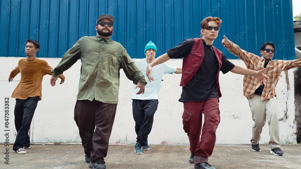 Group of hip hop choreographer dancing street dance together at wall ...