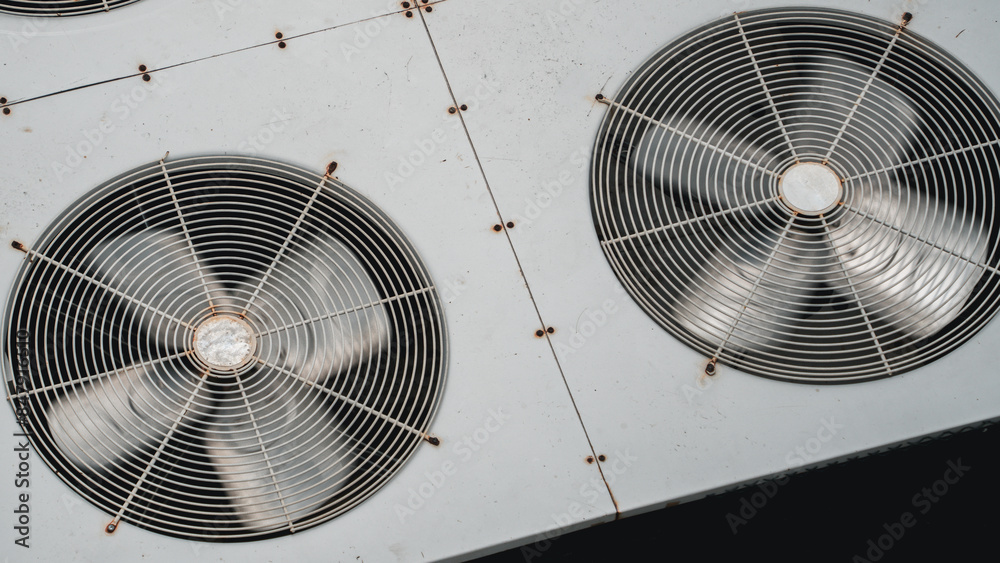 Air conditioner compressor on a building's rooftop, accompanied by ...