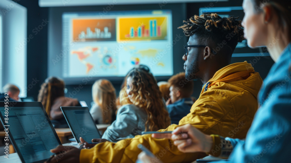 Diverse students engaged in a classroom setting, using laptops and ...