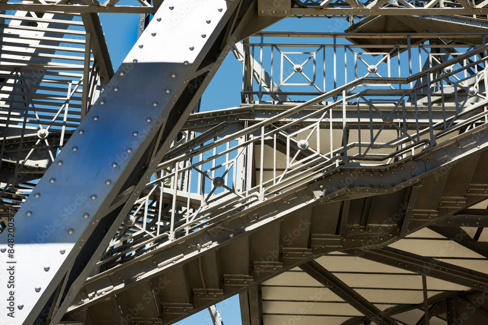 Shot of exterior detail of vintage steel girder structure supporting a ...