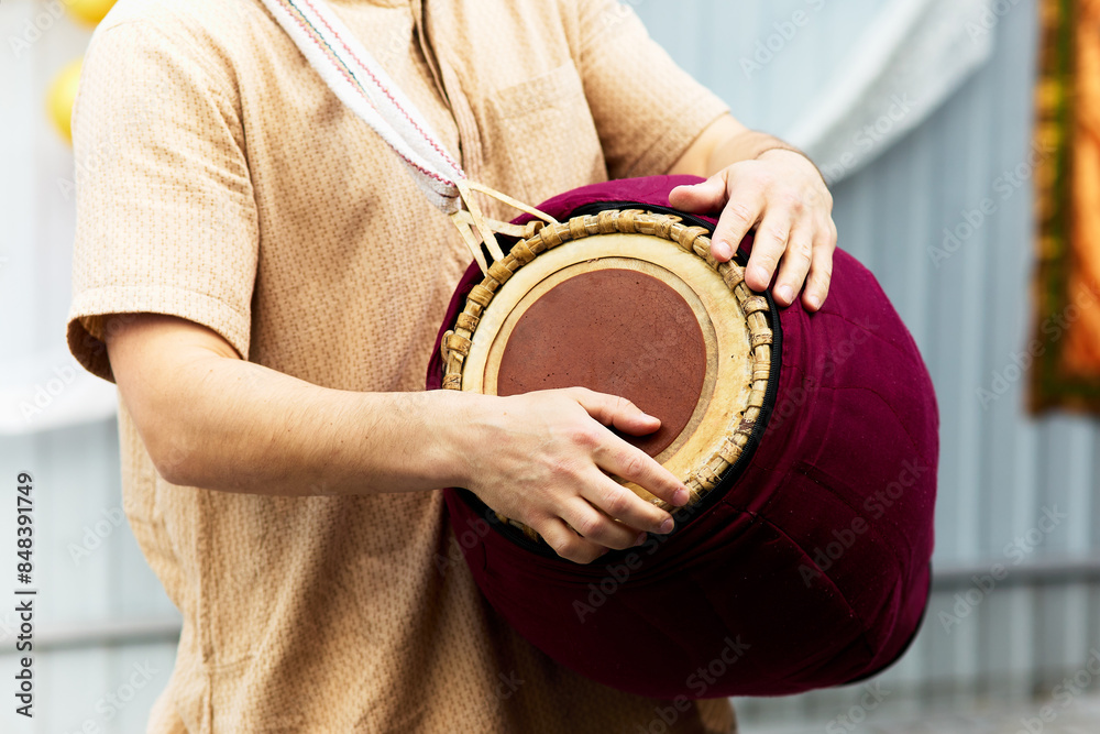 Hare Krishna Man Playing Traditional Indian Instrument Mridanga. Drummer hands playing Mridanga ...