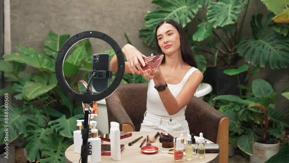 Beautiful content creator making natural beauty and cosmetic tutorial at green plant leave ...