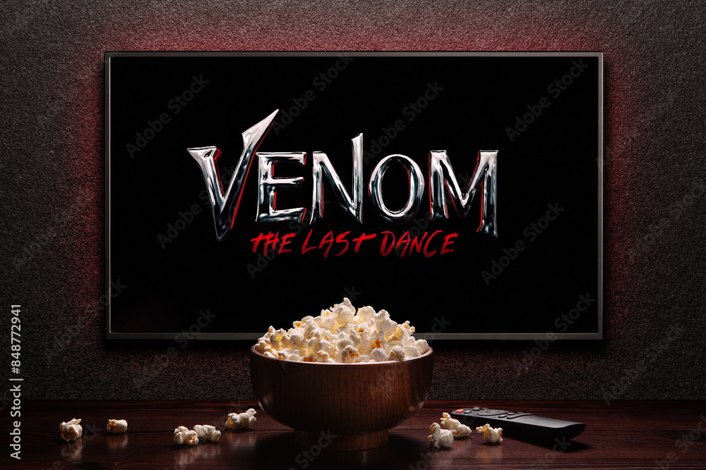 Venom The Last Dance trailer or movie on TV screen. TV with remote ...