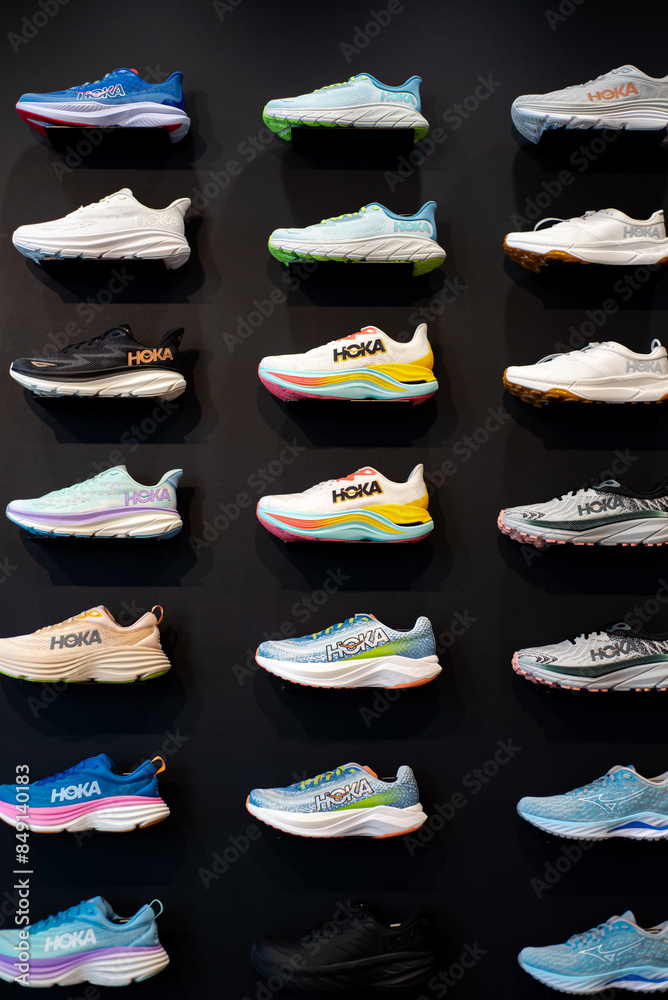 Colorful collection of latest HOKA running shoes on display at upscale ...