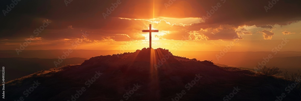 Silhouette of the cross atop Calvary mountain against the backdrop of a ...