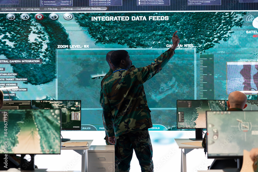 Infantry unit troopers examines satellite surveillance imagery for a ...