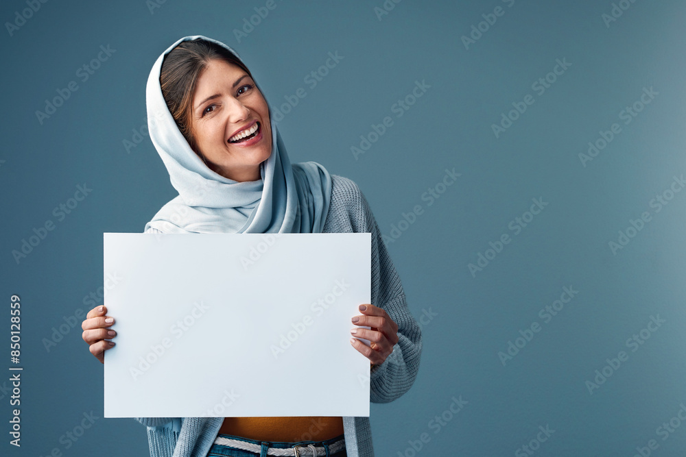 Sign, portrait and islam woman in studio, smile and advertising on blue ...