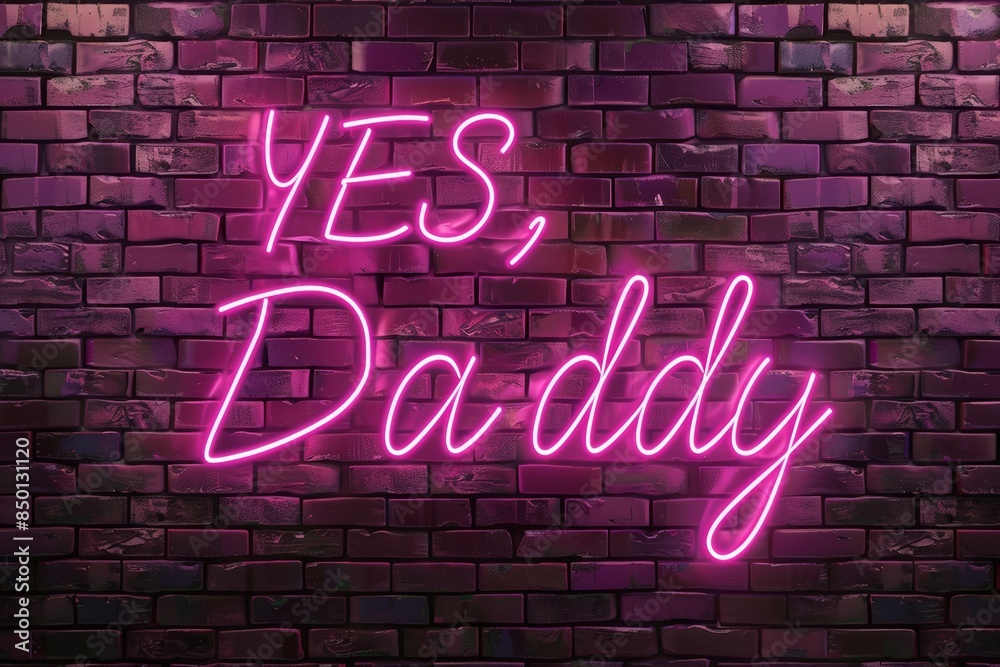 The text Yes, Daddy is written in neon sign in glowing pink color on a ...