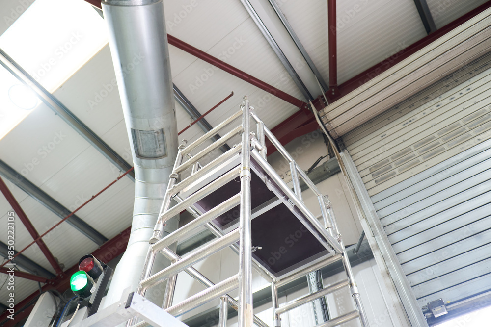 Industrial metal scaffolding pipes and walking board inside an ...