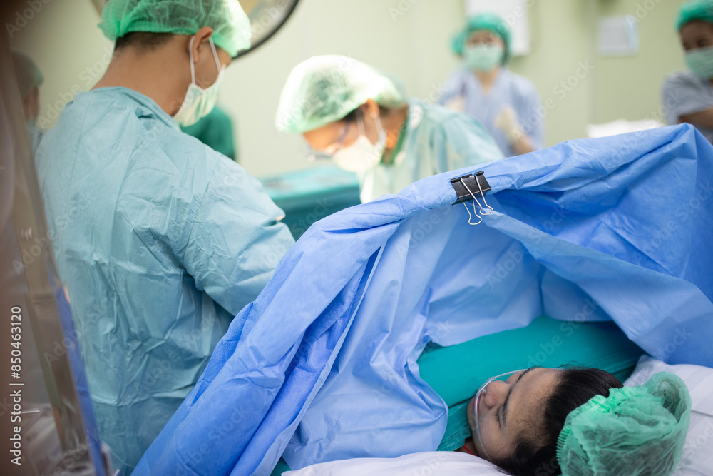 Young Asian mother feel painful during Cesarean sections in delivery ...