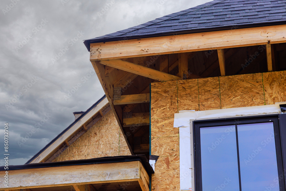 An under construction house has its joist framework with plywood ...
