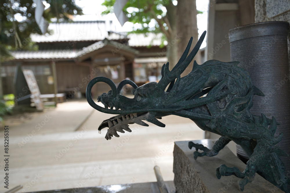 A bronze statue of a dragon spitting water at the Chozuya (purification ...