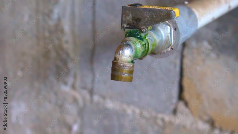Women closes the open water tap. Close-up of a woman's hand closing a ...