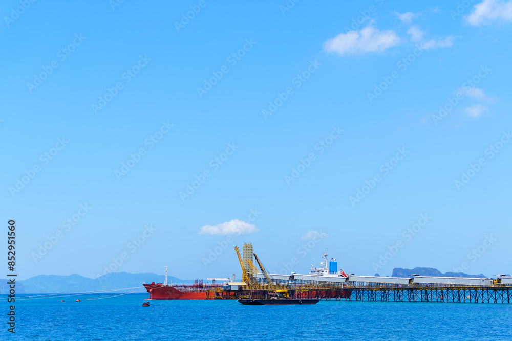 Sea cargo ship with a berth equipped with an overpass, a gantry crane ...