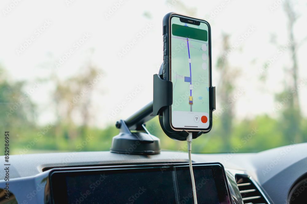 Gps car map system on cellphone screen on phone holder at car dashboard ...