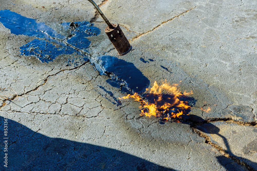 Pavement joints are restored by heating cracks in asphalt prior to ...