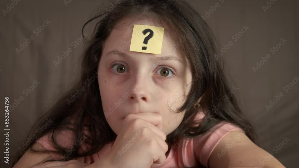 Confused child with question mark. A view of confused little girl think about her question on ...