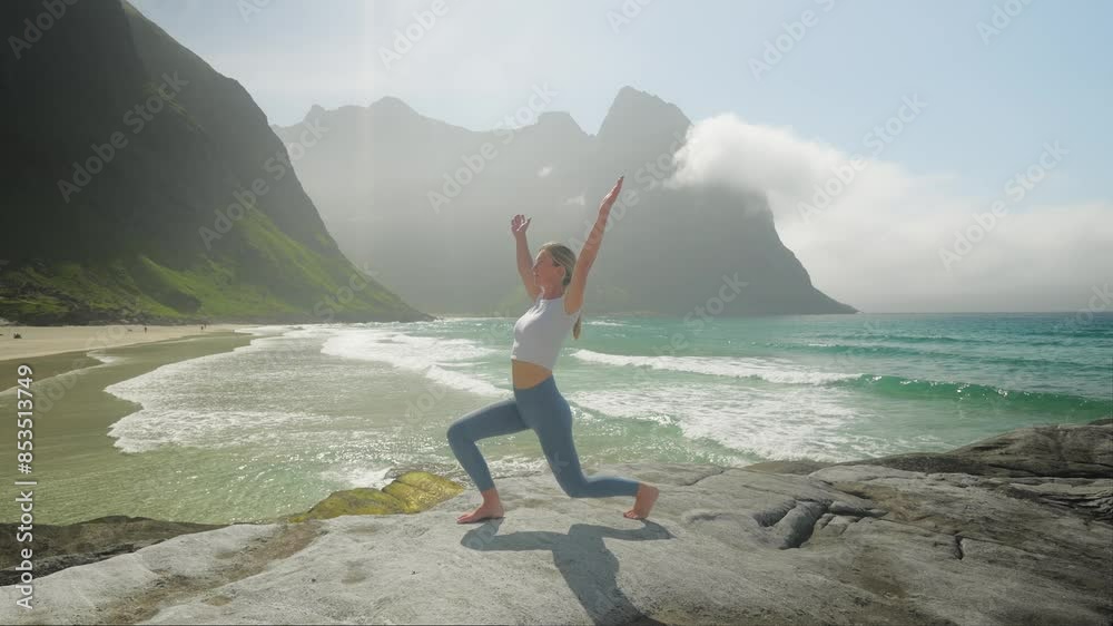 Woman doing morning sun salutation pose in early morning on Norway ...